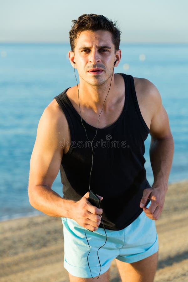 Man jogging on beach stock photo. Image of running, ocean - 259417312