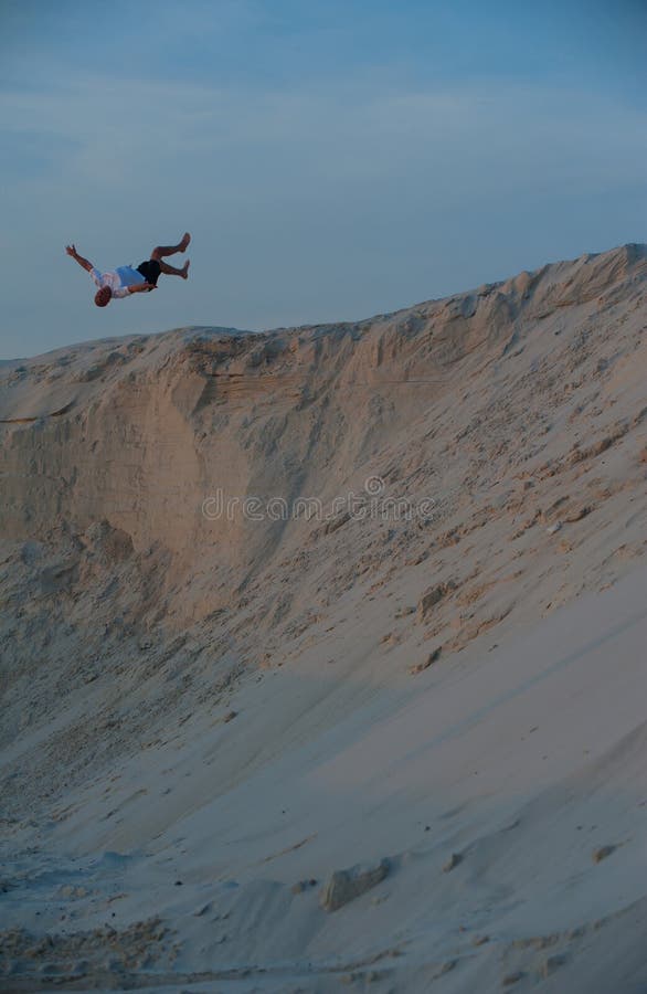 Man in a jump on the beach stock photo. Image of summer - 66790798
