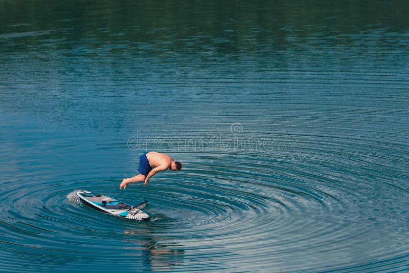 Man Jump from Supboard into the Water Stock Photo - Image of season ...