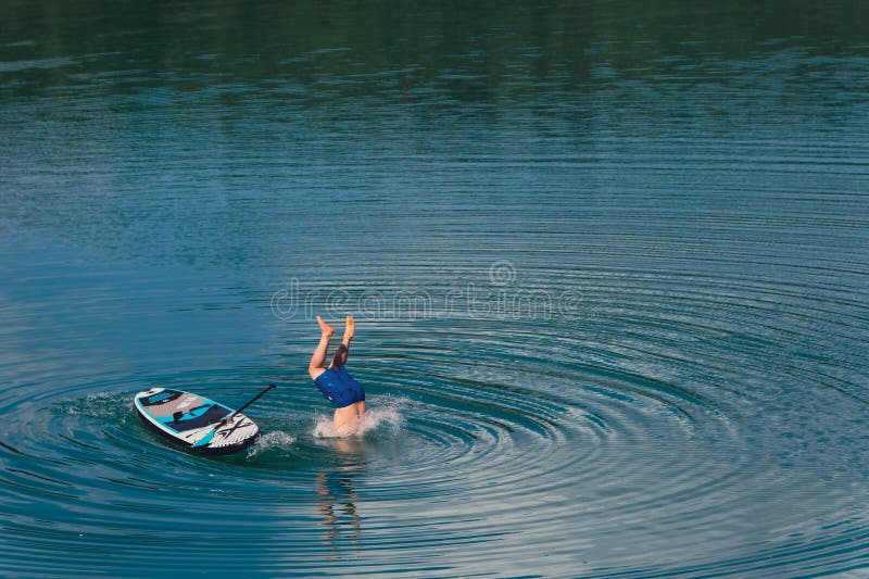 Man Jump from Supboard into the Water Stock Photo - Image of ...