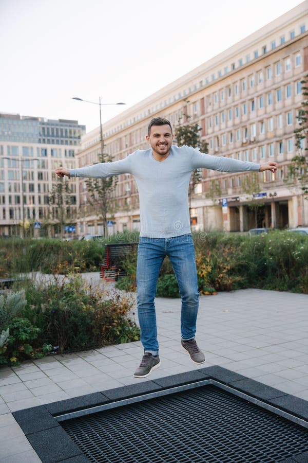 Man Jump on Trampoline in Centre of the City. Central Park in Poland ...