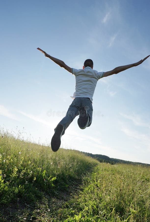Man Jumping in the Sunshine Against Blue Sky Stock Image - Image of ...