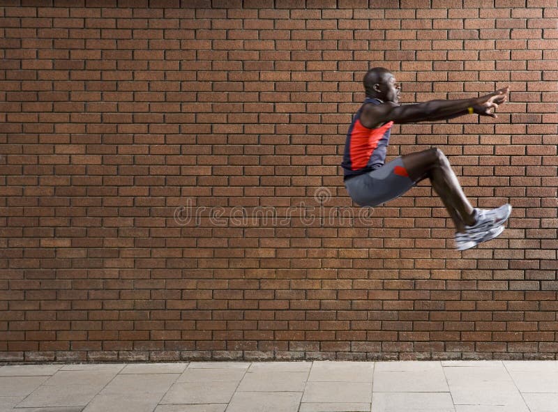 Man Jumping Against Brick Wall Stock Photo - Image of athletic, agility ...