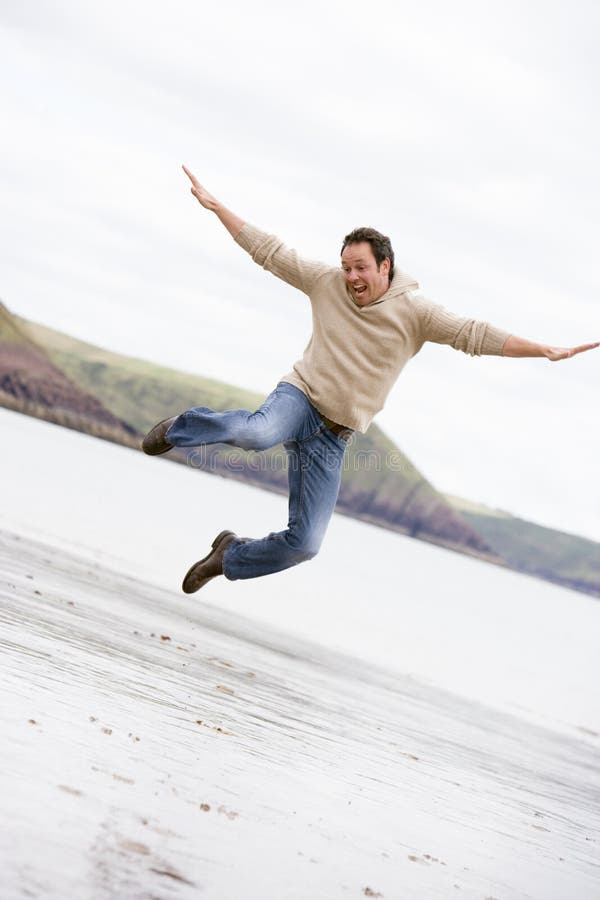Man jumping on beach stock image. Image of full, outside - 5937711