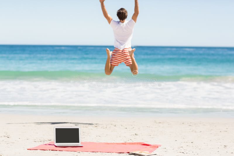 Man jumping on beach stock photo. Image of ocean, adult - 77875520