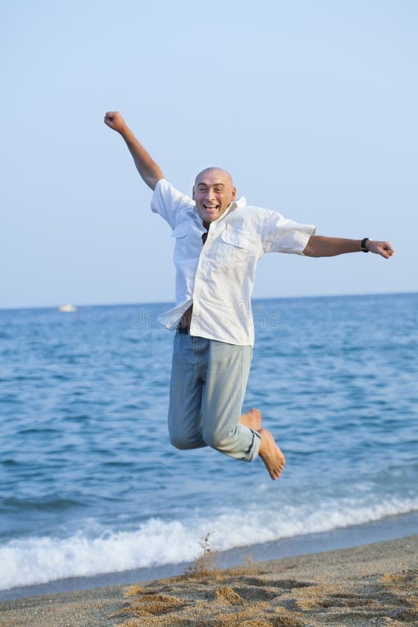 Man jumping on beach stock image. Image of vacation, shirt - 45458153