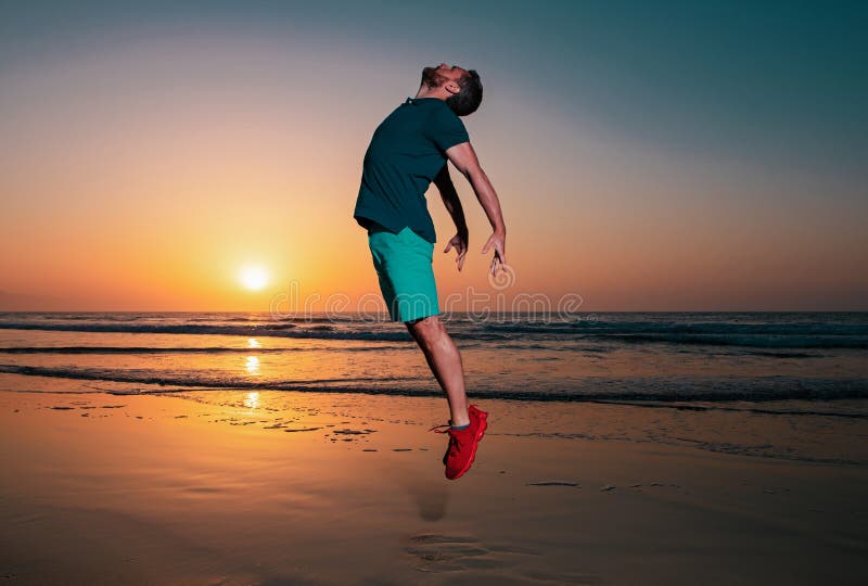 Man Jumping on Beach, Silhouette in the Sunset. Feel Good and Freedom ...