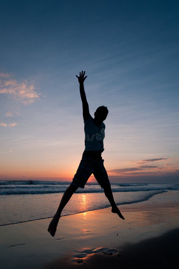Man Jumping on the Beach at the Sunset Stock Photo - Image of rised ...