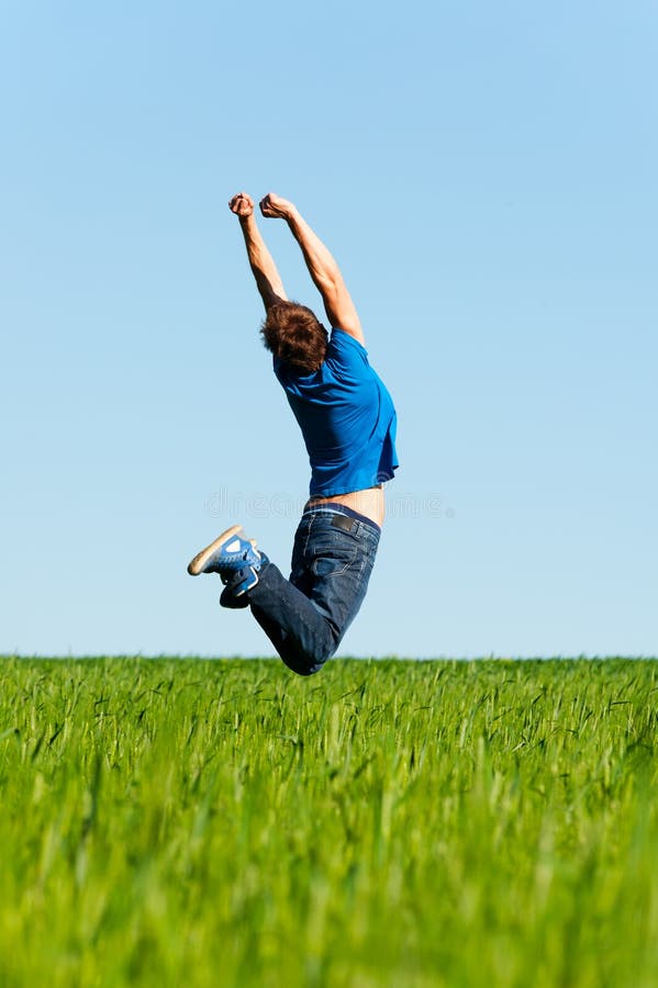 Man Jumping on the Green Field Stock Image - Image of leap, healthy ...