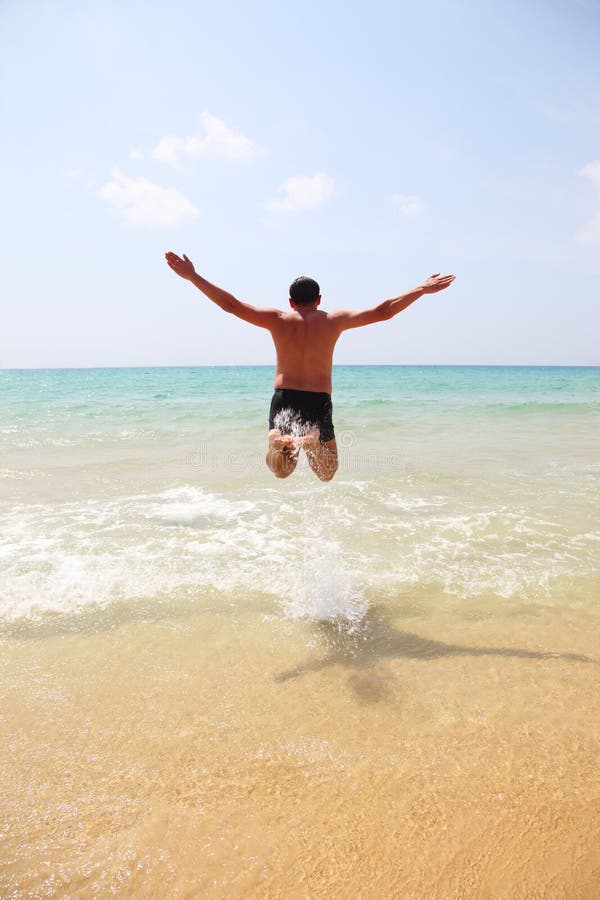 Man Jumping High Up into the Air Stock Image - Image of beach ...