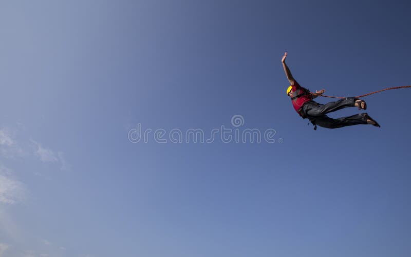 Man jumping off a cliff. stock photo. Image of color - 71844700