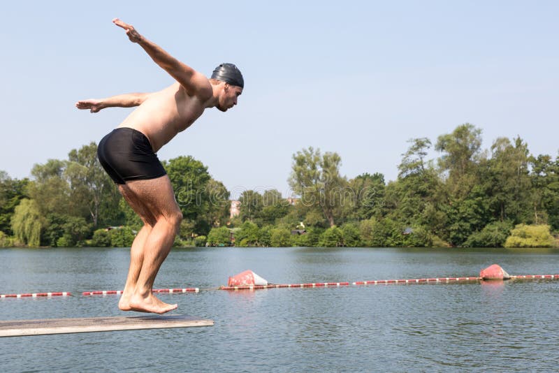 Man Jumping Off Diving Board at Swimming Pool Stock Image - Image of ...