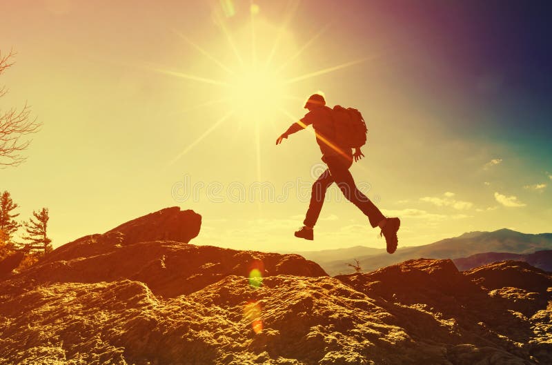 Man Jumping Over Gap on Mountain Hike Stock Photo - Image of climb ...