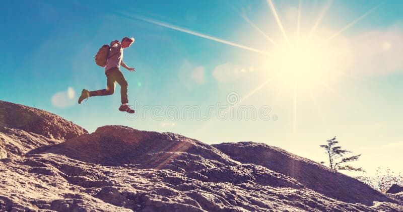 Man Jumping Over Gap on Mountain Hike Stock Image - Image of ledge ...