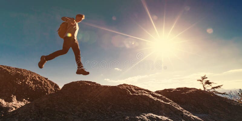 Man Jumping Over Gap on Mountain Hike Stock Image - Image of adventure ...