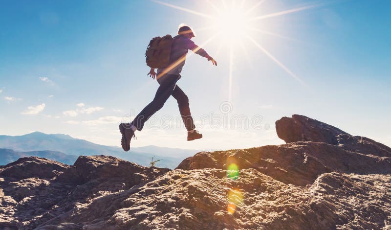 Man Jumping Over Gap on Mountain Hike Stock Photo - Image of high, leap ...