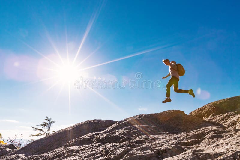 Man Jumping Over Gap on Mountain Hike Stock Image - Image of ledge ...