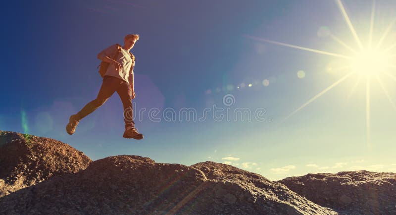 Man Jumping Over Gap on Mountain Hike Stock Photo - Image of autumn ...
