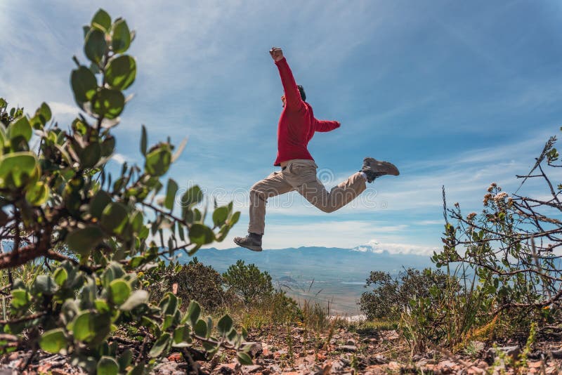 Man Jumping Over Rocks in Mountain Stock Photo - Image of success ...