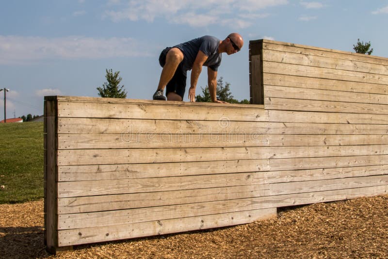 Man Jumping Over Wall stock image. Image of handsome - 20354579