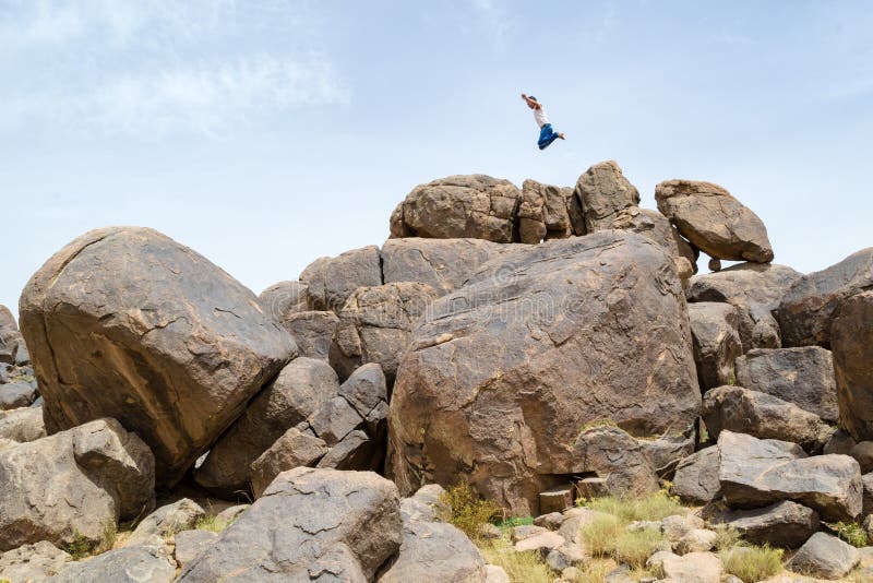 Man Jumping on Rocks in the Desert #1 Stock Image - Image of commercial ...