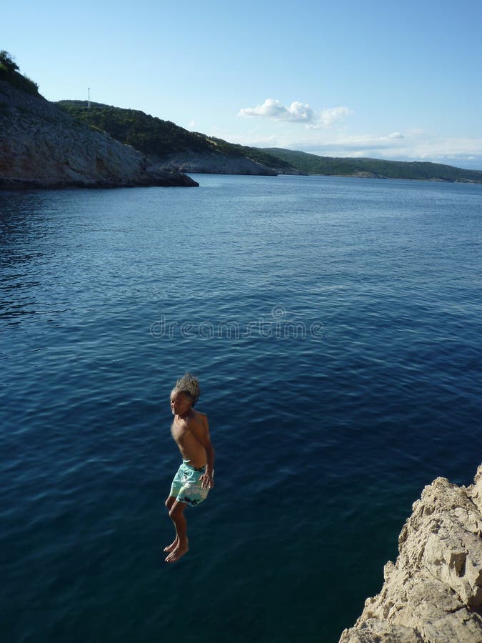 Man jumping in the sea stock image. Image of danger, cloud - 43749527