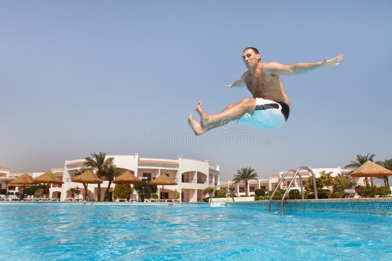 Man Jumping in Swimming Pool Stock Image - Image of resort, jumping ...