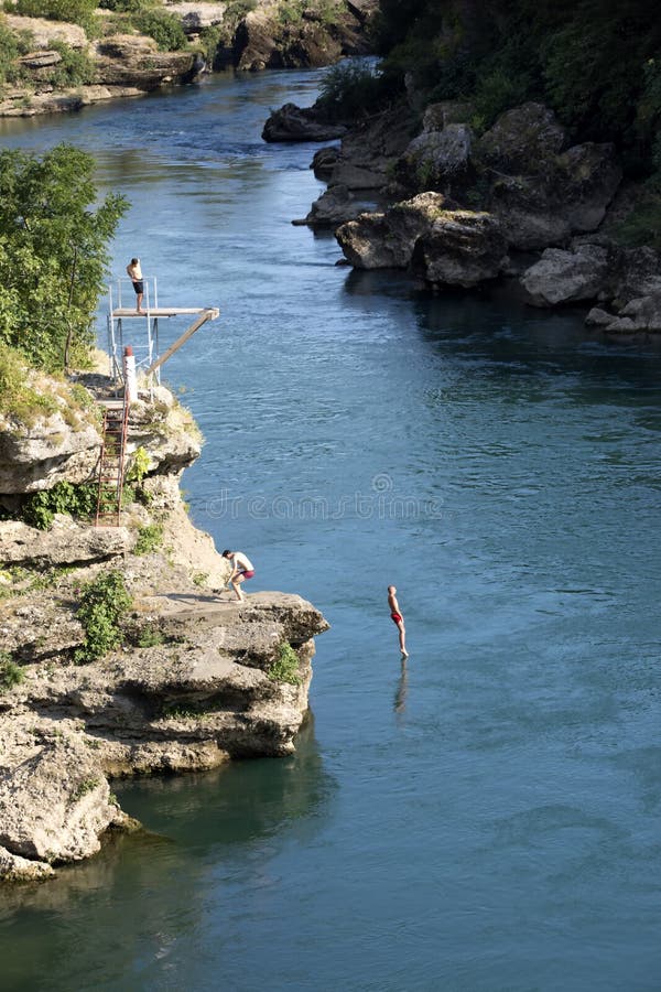Man jumping to the river editorial stock image. Image of outdoors ...