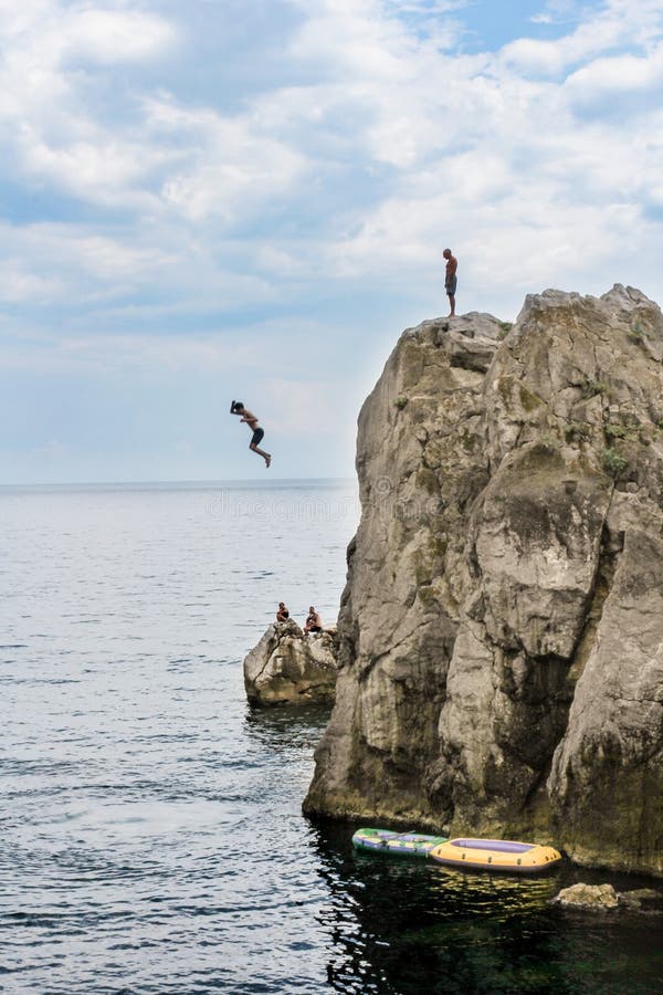 Man Jumps from a Cliff into the Sea Editorial Image - Image of water ...