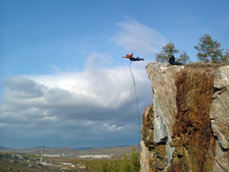 A Man Jumps from the Edge of the Cliff into the Abyss. Stock Image ...