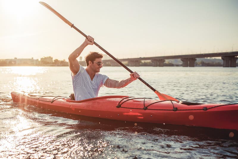 Man kayaking on sunset stock photo. Image of happy, health - 97893058