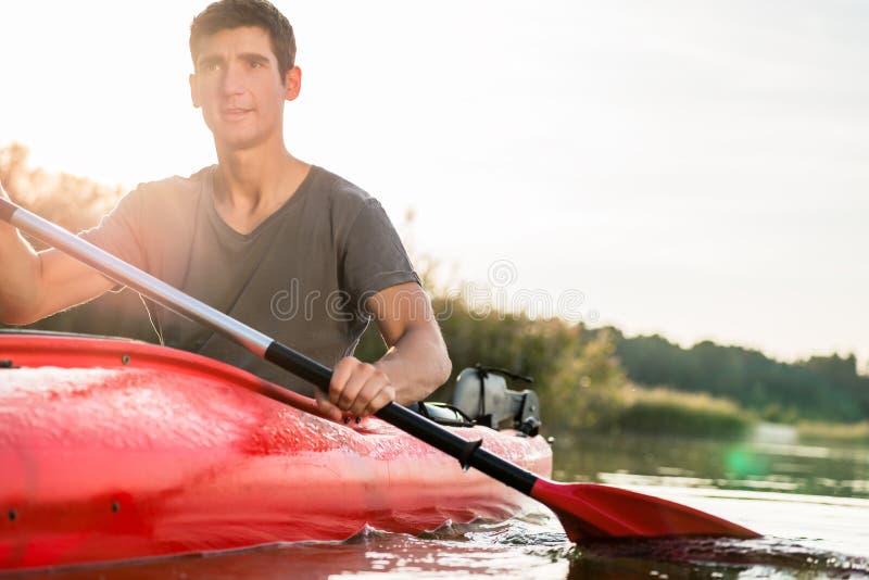 Man kayaking using paddle stock image. Image of lake - 131299463