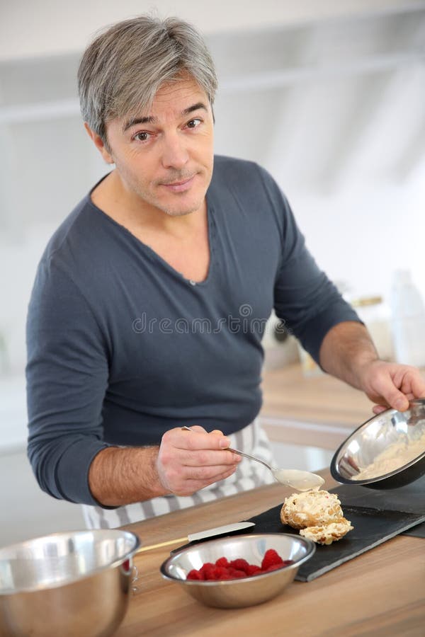 Man in the kitchen cooking stock image. Image of puff - 65338959