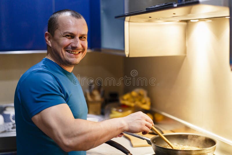Man in the Kitchen is Cooking at Home at the Wok Stock Photo - Image of ...
