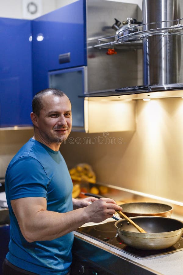 Man in the Kitchen is Cooking at Home at the Wok Stock Photo - Image of ...