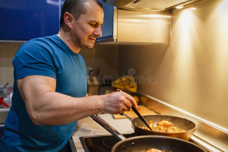 Man in the Kitchen is Cooking at Home at the Wok Stock Photo - Image of ...