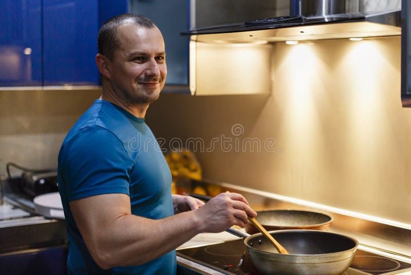 Man in the Kitchen is Cooking at Home at the Wok Stock Photo - Image of ...