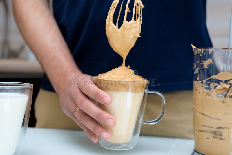 A Man in the Kitchen is Preparing Dalgona Coffee, Whipped with a Mixer ...