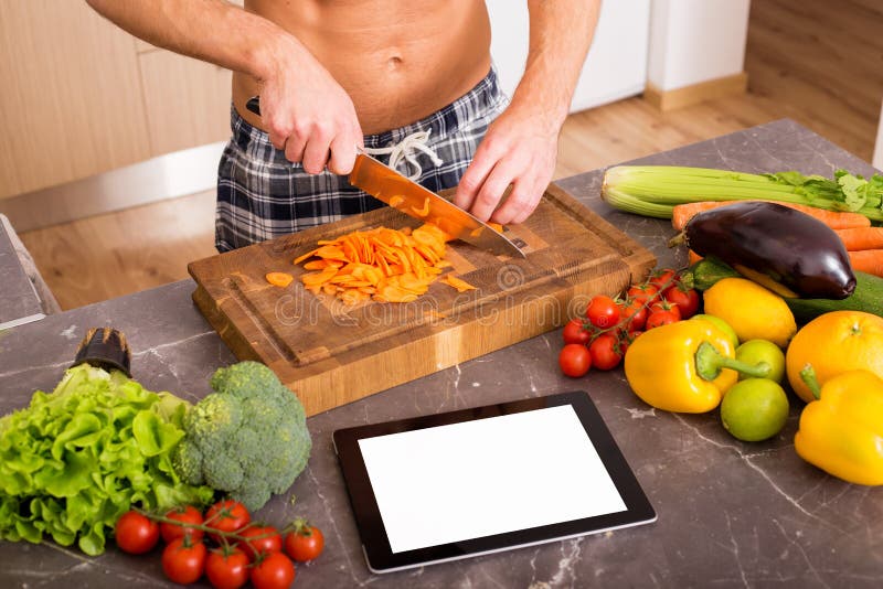 Man in Kitchen Using Tablet for Cooking Recipe Stock Image - Image of ...