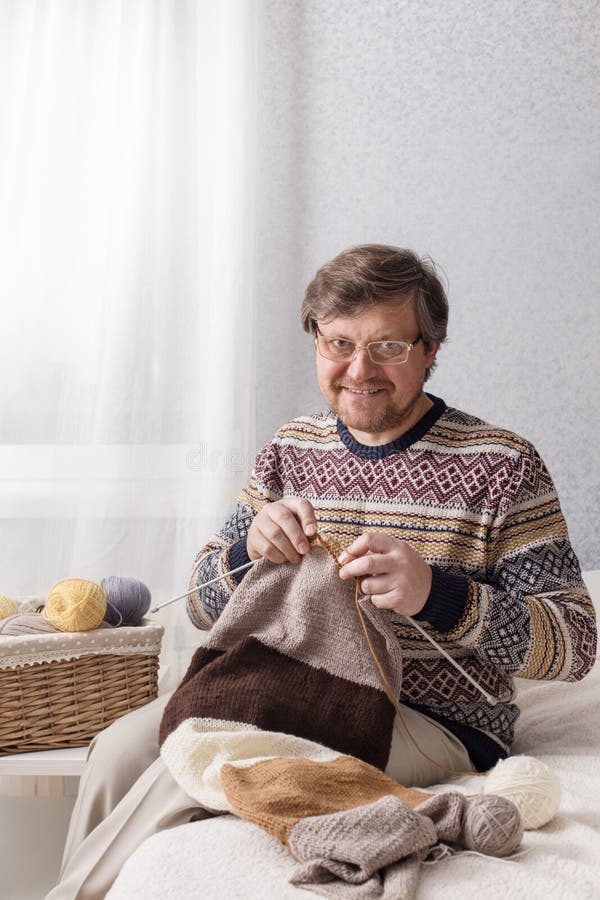 The man knits at home stock photo. Image of hand, happy - 106989312