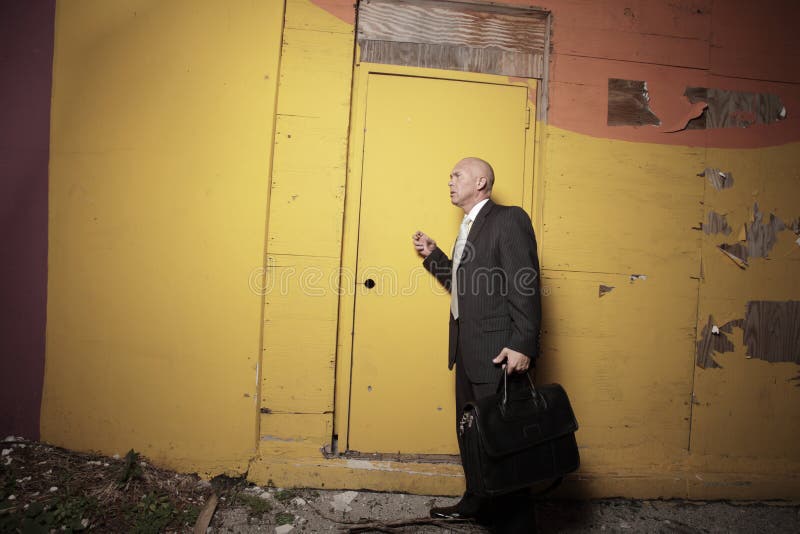 Man Knocking on a Yellow Door Stock Photo - Image of outdoor, darkness ...