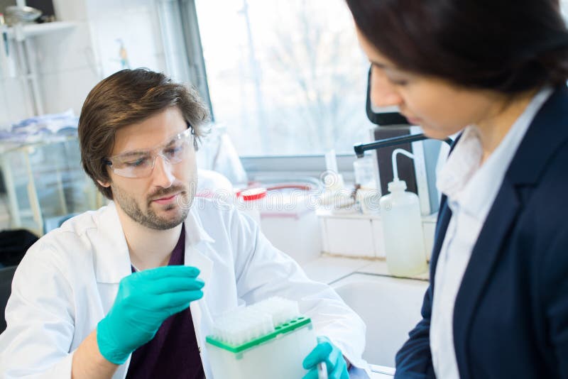 Man in Lab Coats and Woman Manager Talking Stock Image - Image of ...
