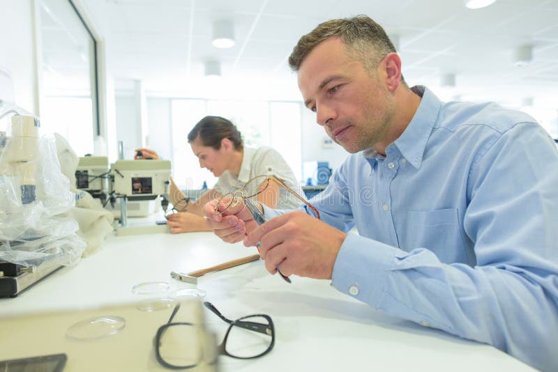 Man in Lab Fixes Glasses for Vision Stock Image - Image of optic ...