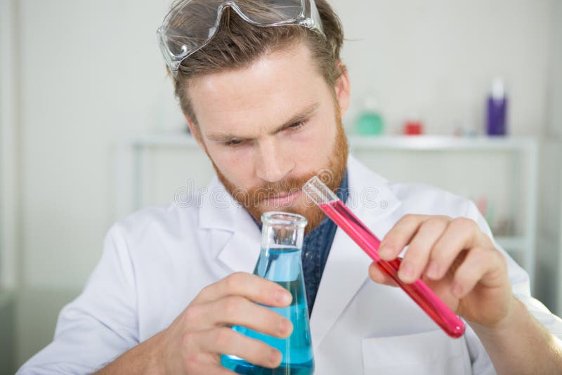 Man in Lab Testing Different Colour Liquids Stock Photo - Image of ...