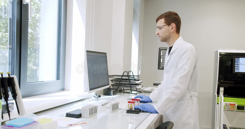 Man Laboratory Technician Working in Hospital with Modern Equipment ...