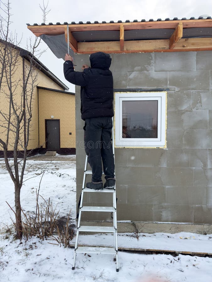 A Man is on a Ladder, Fixing a Roof Stock Photo - Image of equipment ...
