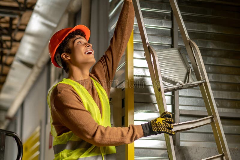 Smiling Warehouse Worker with the Ladder Stock Photo - Image of high ...