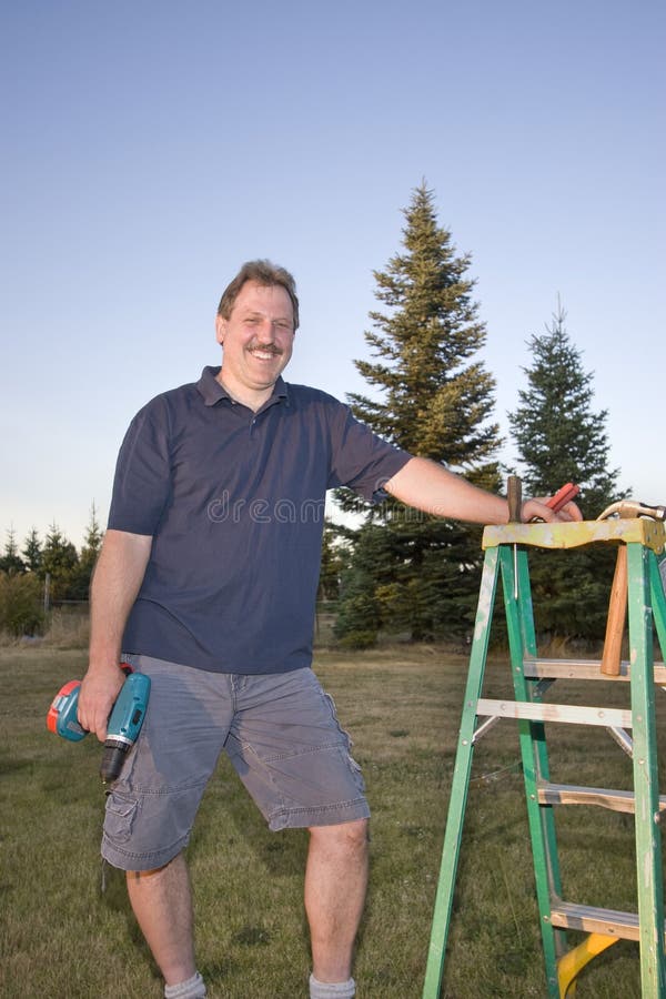 Man with Ladder - Vertical stock photo. Image of drill - 5975398