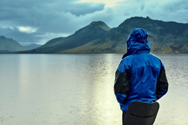 Man on the Lake Coast with Mountain Reflection, Iceland Stock Photo ...