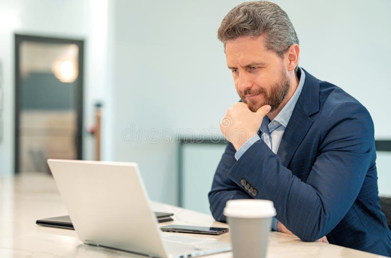 Man with Laptop at Office. Business Man in Suit in Office Work on ...